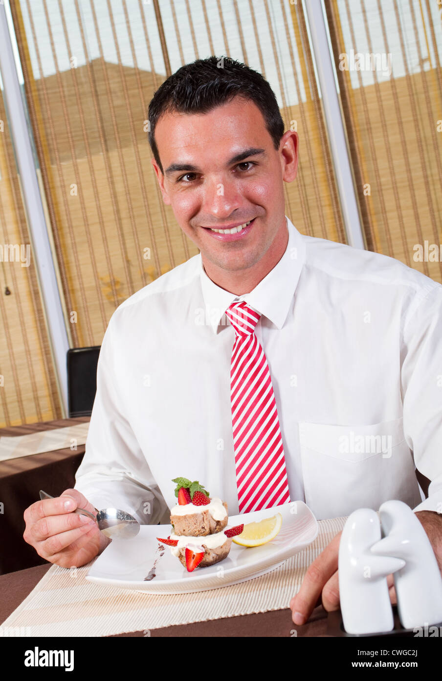 male customer eating dessert in café Stock Photo - Alamy