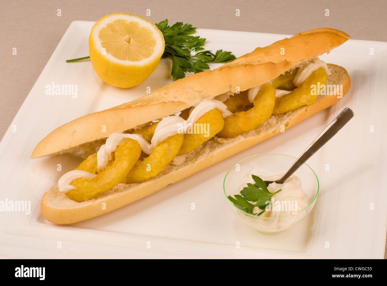 Spanish bread roll with fried squid ring, a popular bocata Stock Photo ...