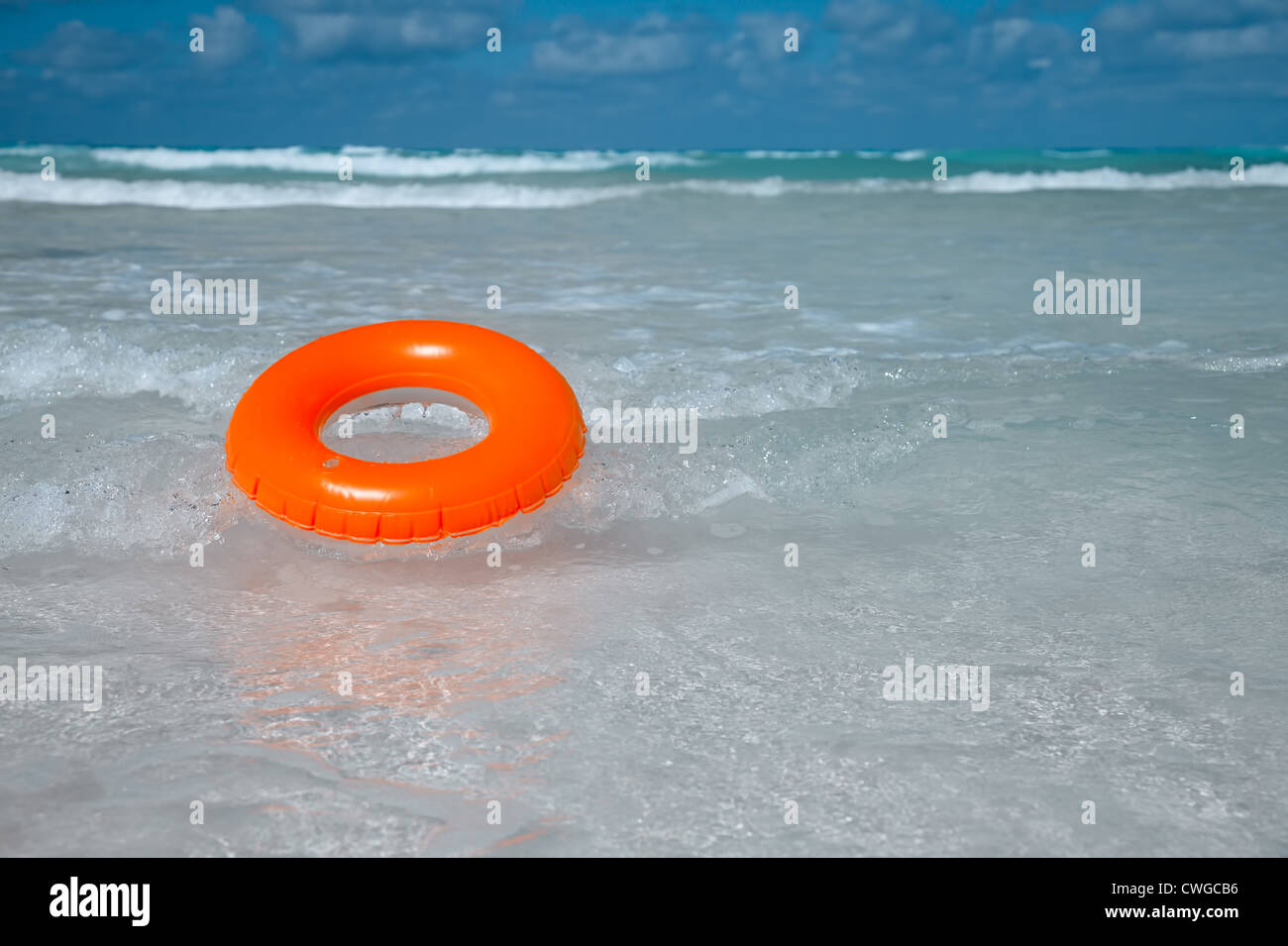 orange floating ring on water by the beach in the summer sun Stock ...
