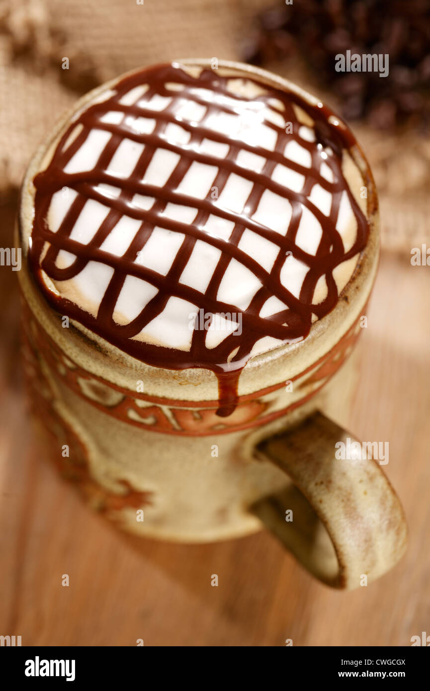 hot frothy coffee cappuccino chocolate topping, in rustic style ...