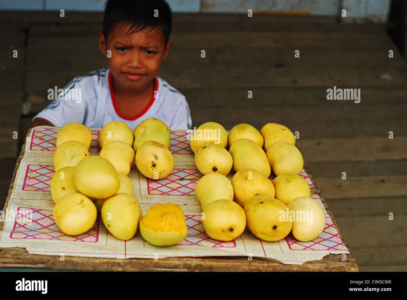Malaysia, Borneo, Semporna, young boy selling mango Stock Photo - Alamy