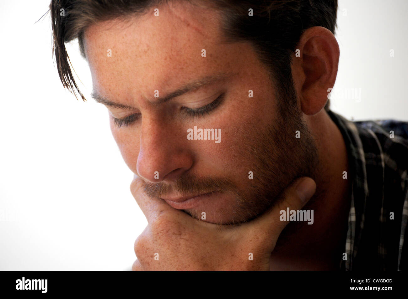 Young man working thinking Stock Photo - Alamy
