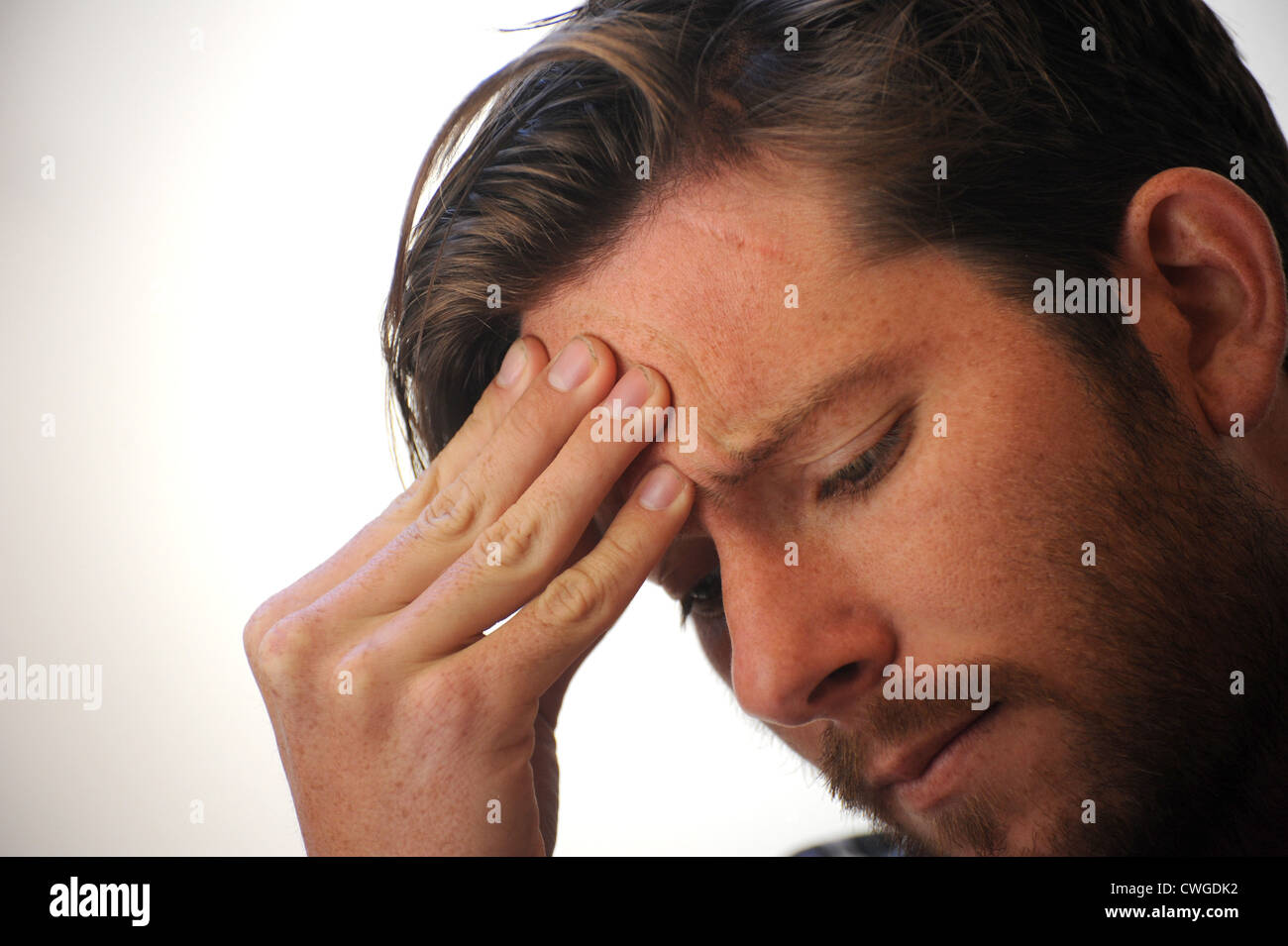 Young man working thinking Stock Photo - Alamy