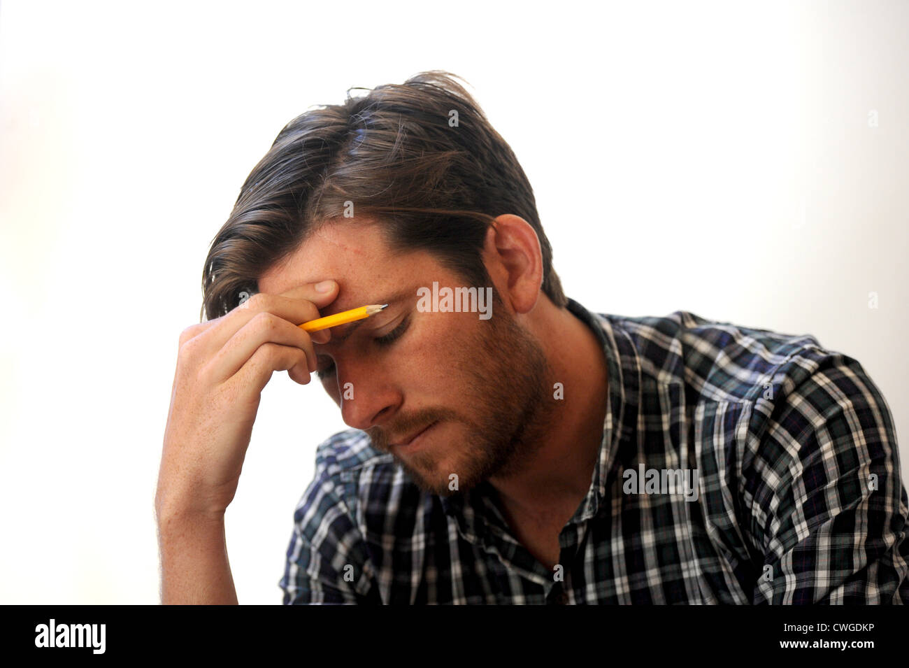 Young man working thinking Stock Photo - Alamy
