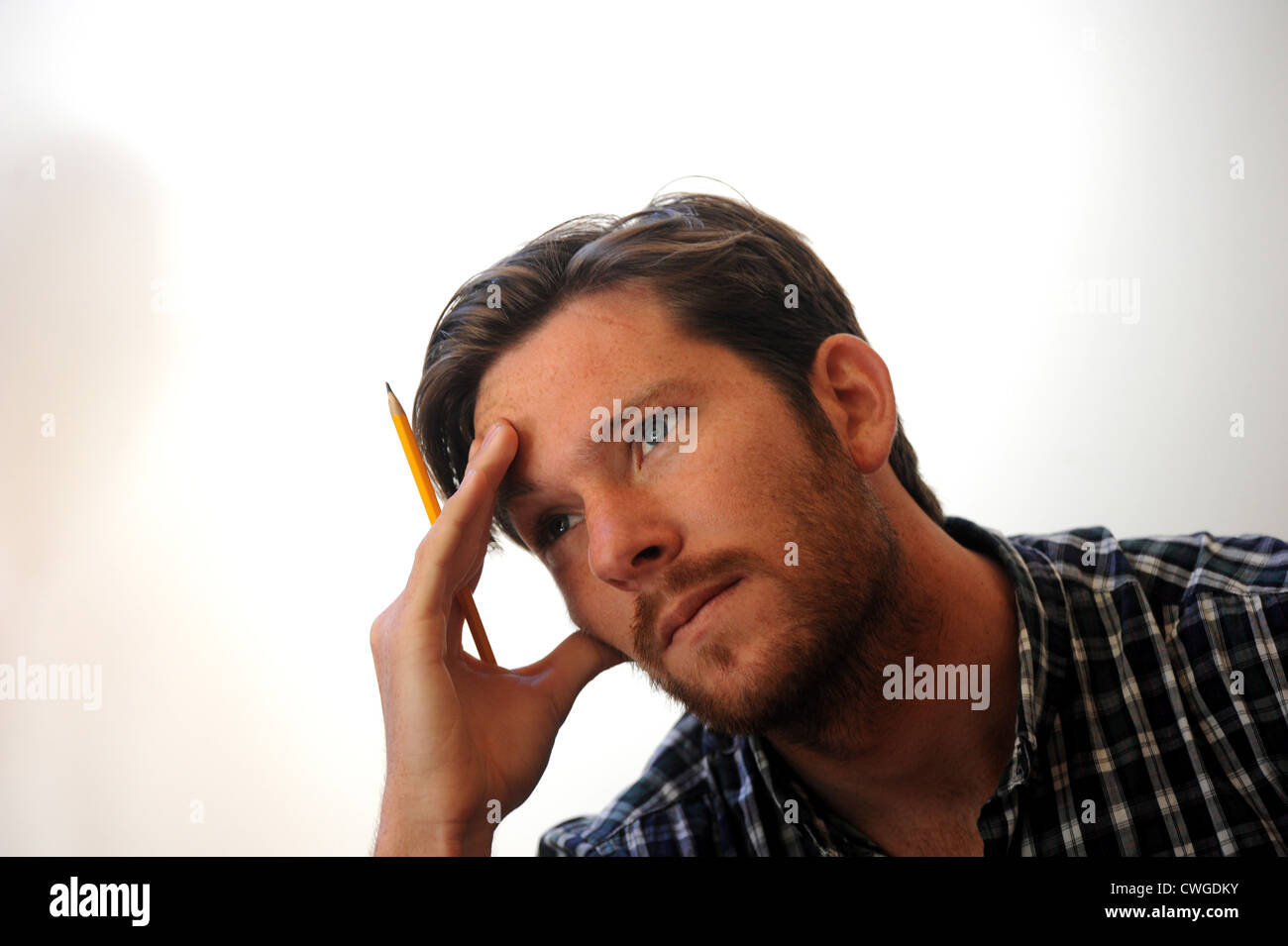 Young man working thinking Stock Photo - Alamy
