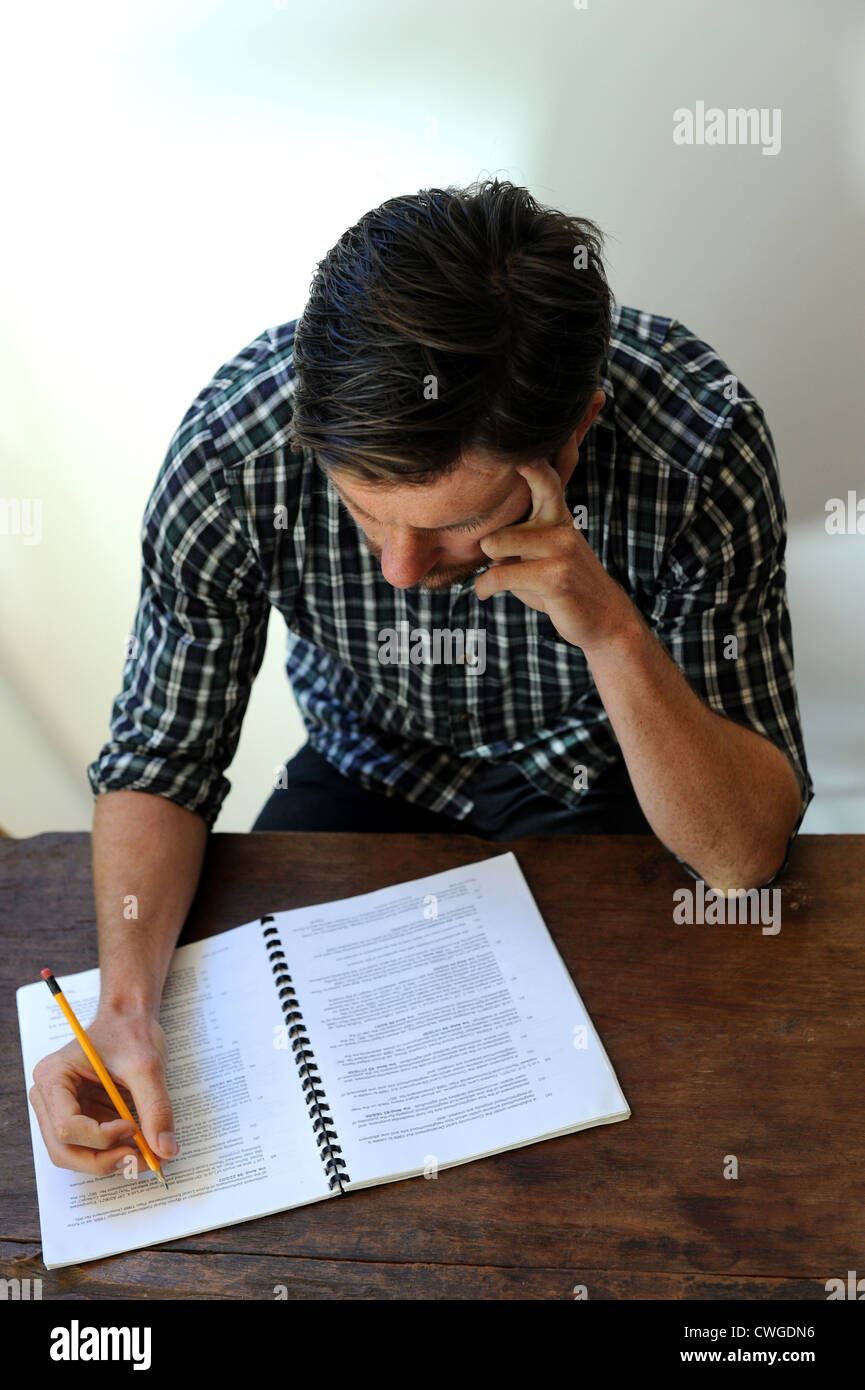 Young man working thinking Stock Photo - Alamy