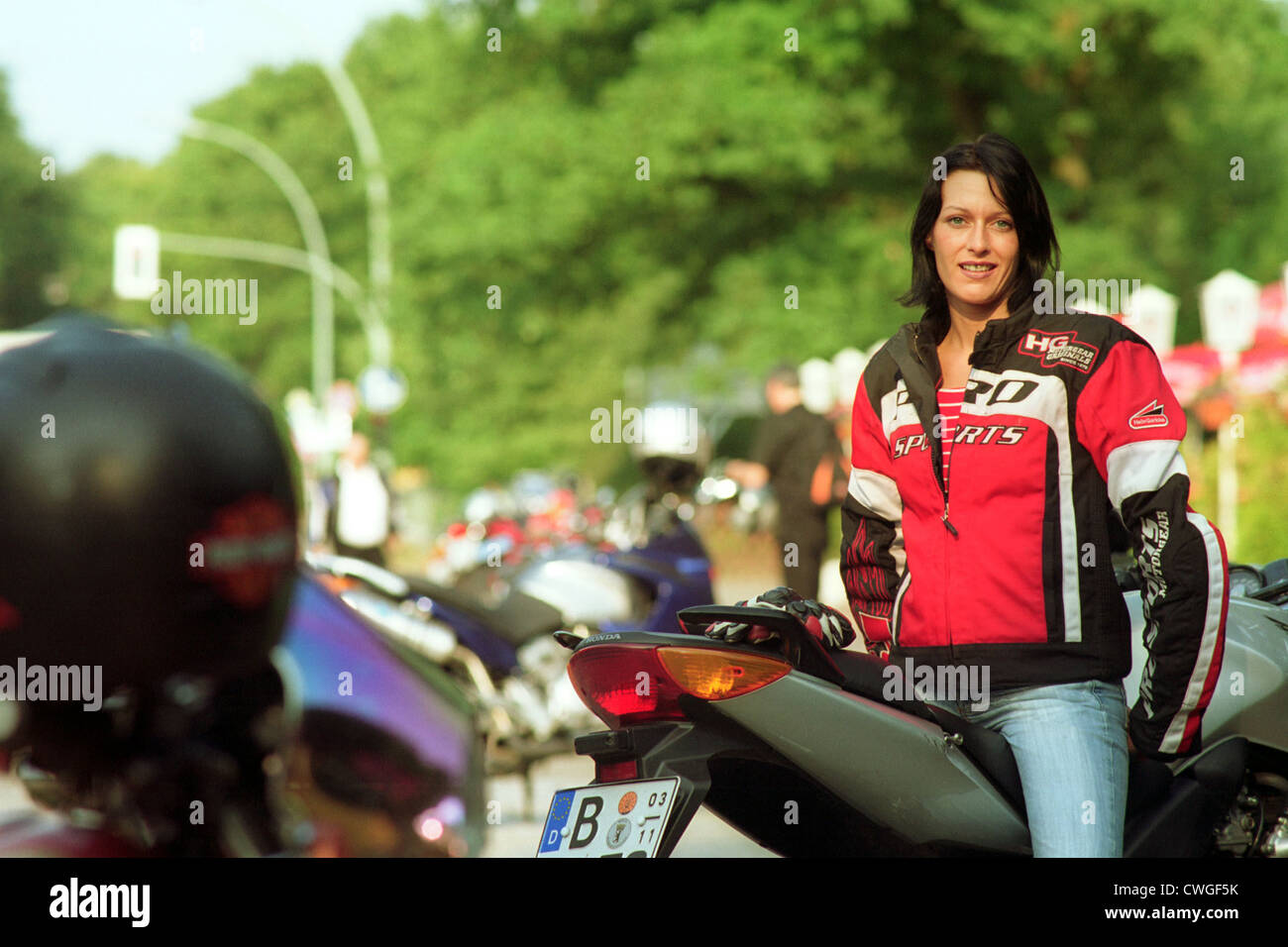 Berlin, Young woman with motorcycle Stock Photo - Alamy