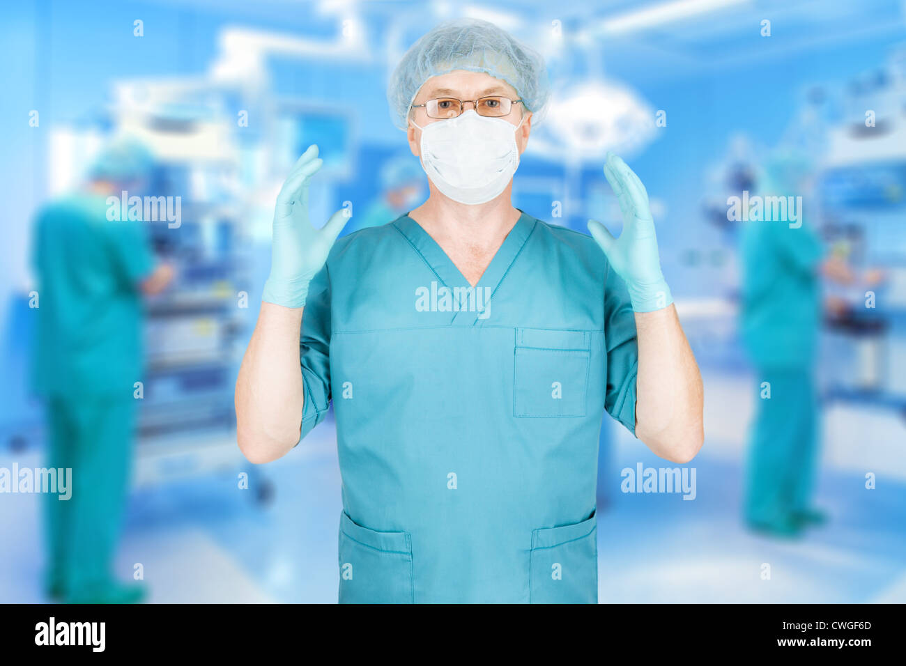 Male surgeon with raised up hands in operative room Stock Photo - Alamy