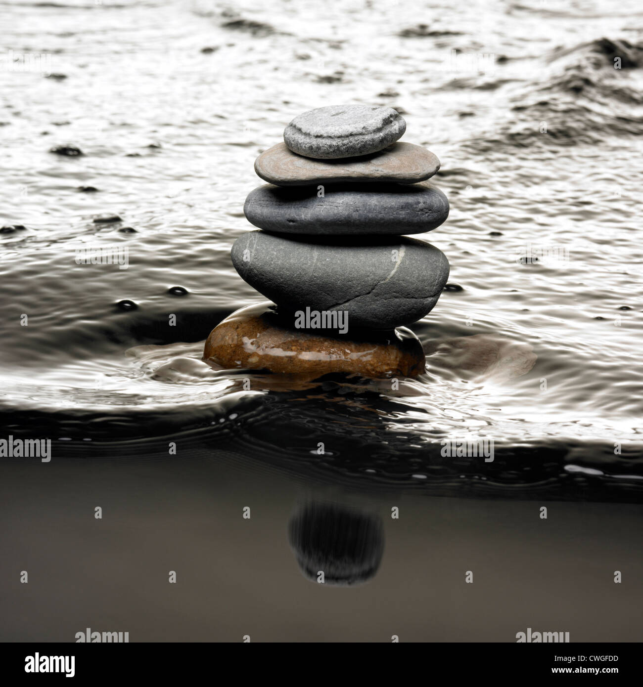 Stones on Water pebbles on beach with tide rushing in. Stones on moving ...