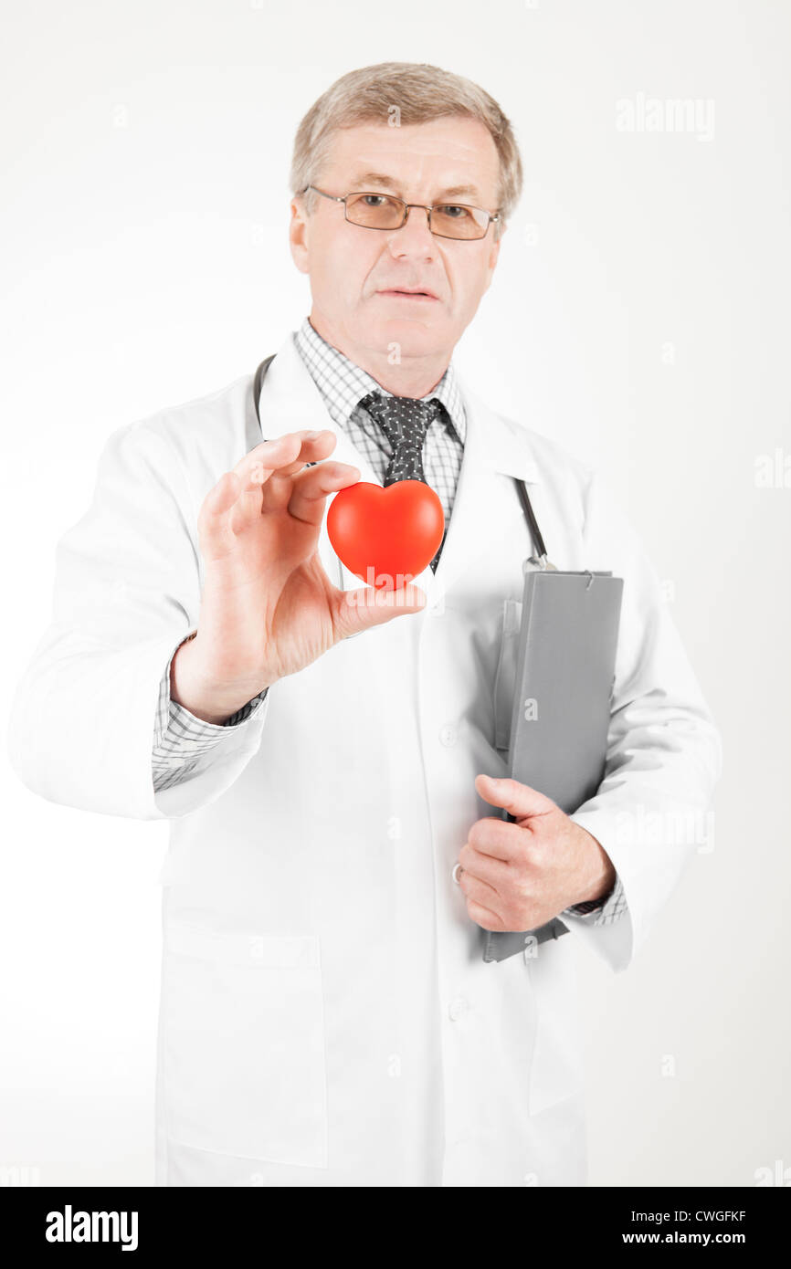 Doctor with heart in his hand - studio shoot Stock Photo - Alamy