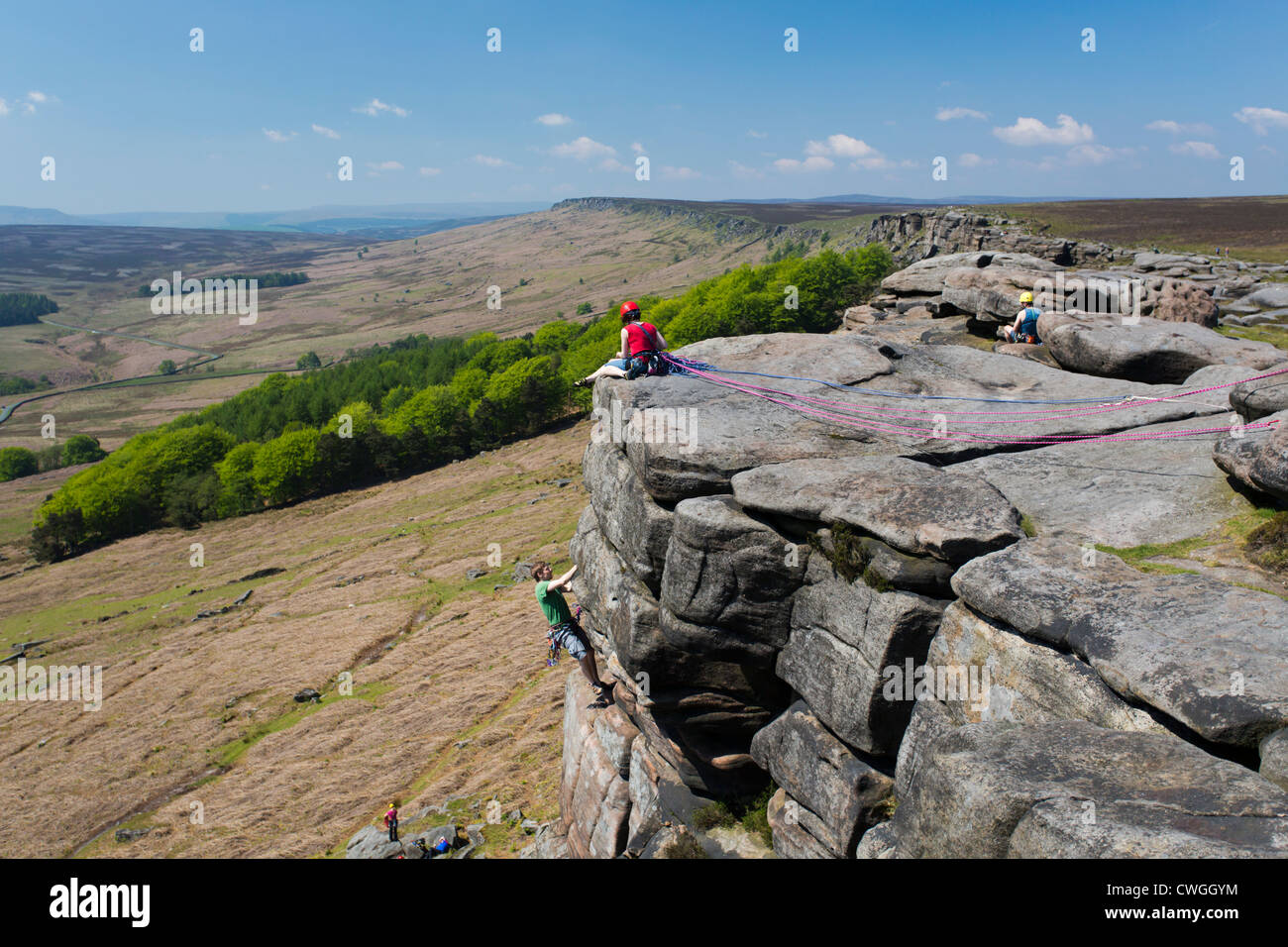 Rock climbers on Stanage Edge in the Peak District Derbyshire England ...