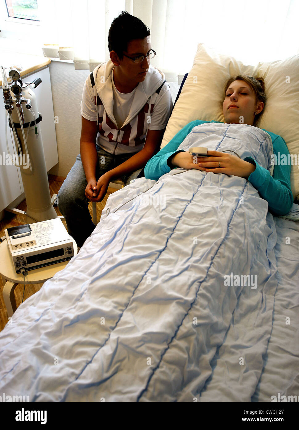Patient with a partner after ambulatory surgery in the recovery room ...