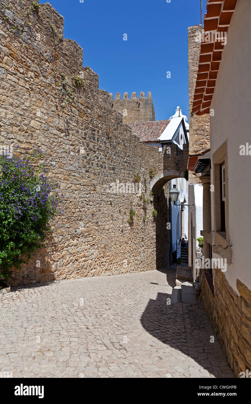 Typical street of Obidos near the castle fortifications. Obidos is a ...