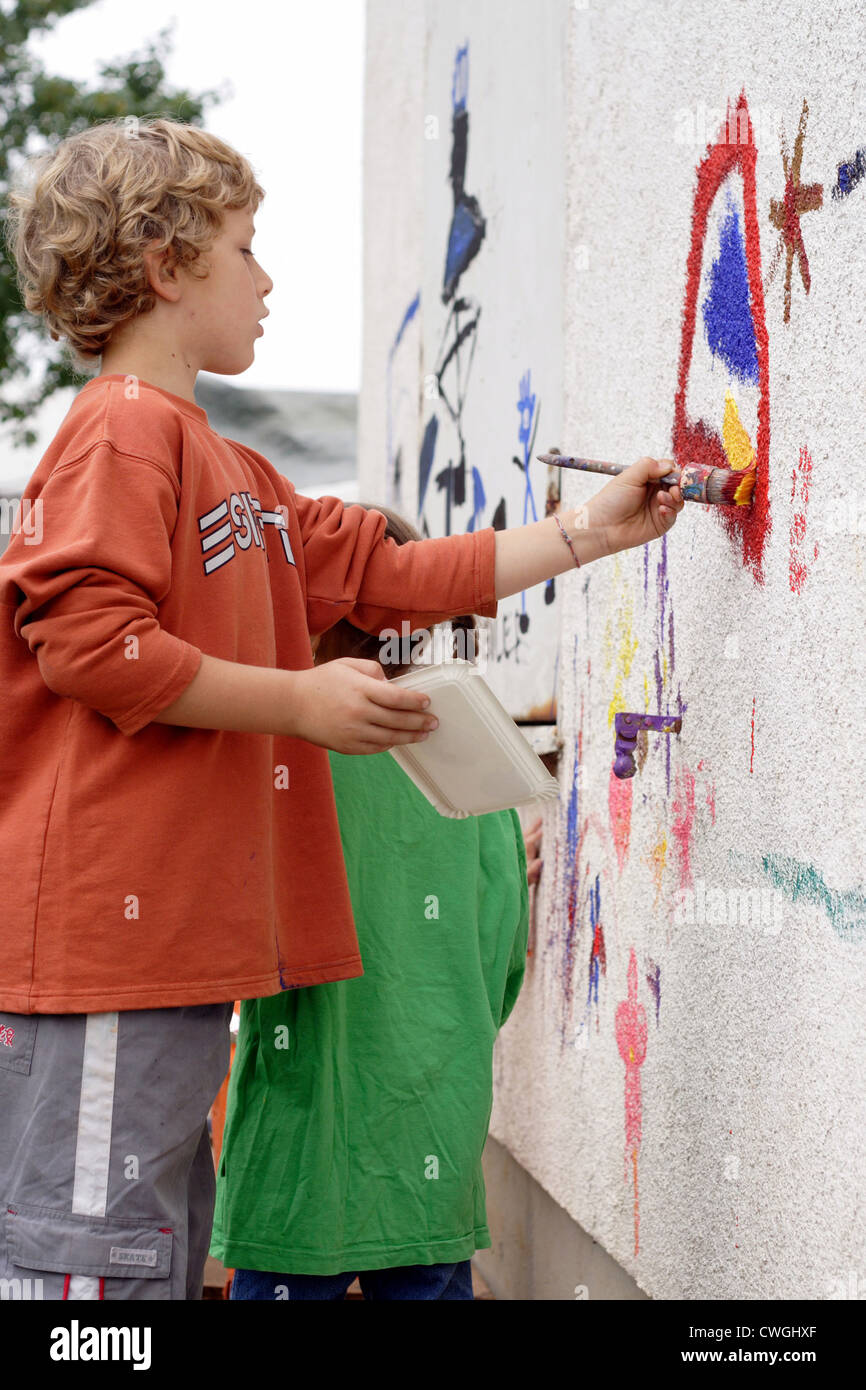 A boy painting a house wall Stock Photo - Alamy