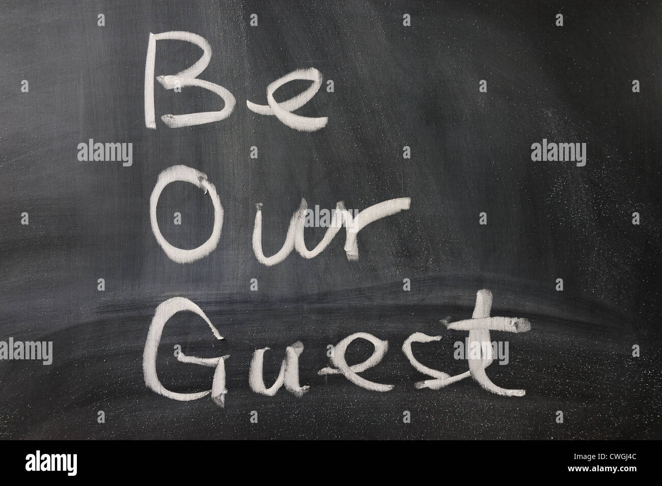 Be our guest words written on the blackboard Stock Photo - Alamy