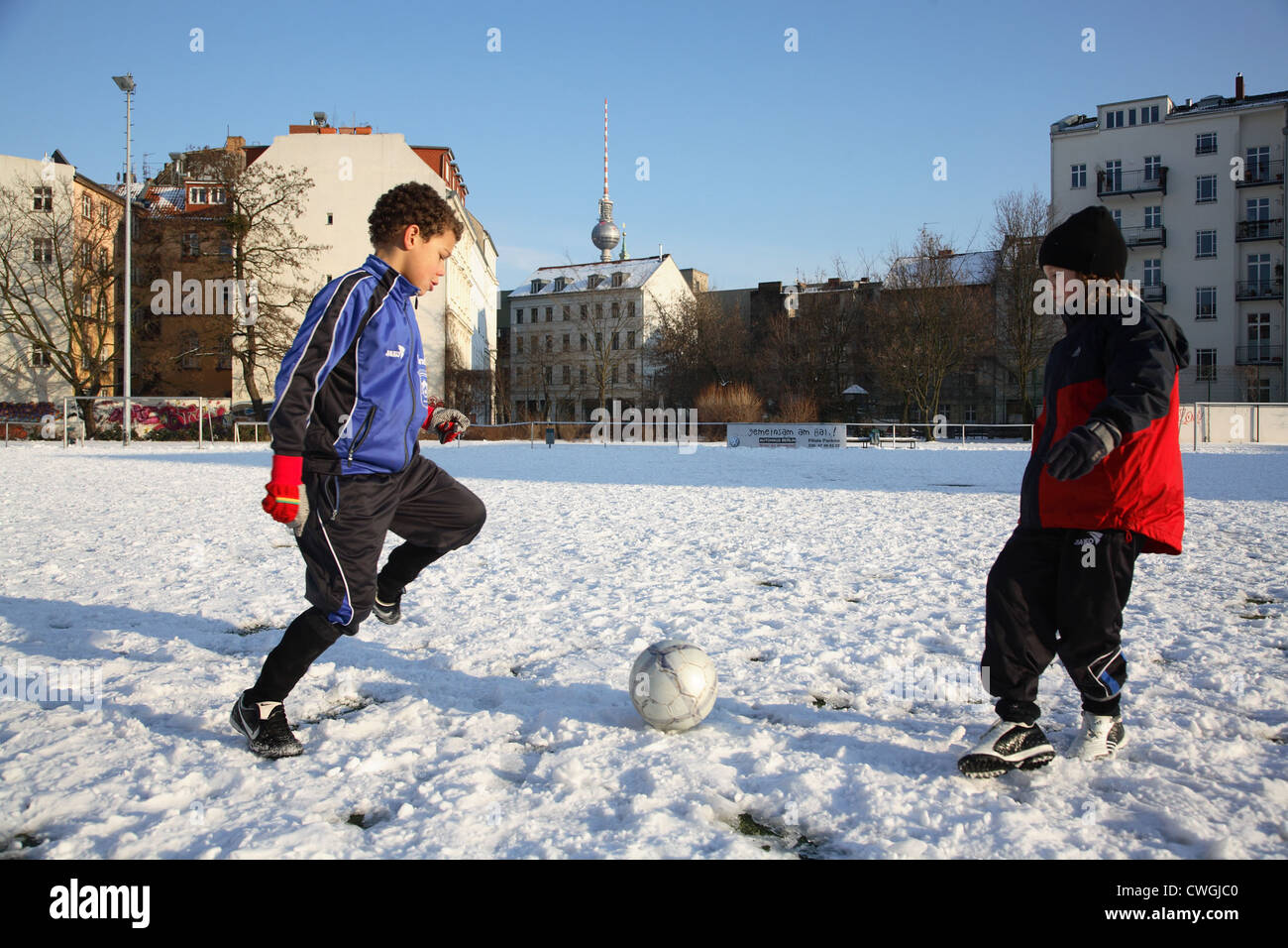 Boys playing football in the snow in Berlin Stock Photo - Alamy