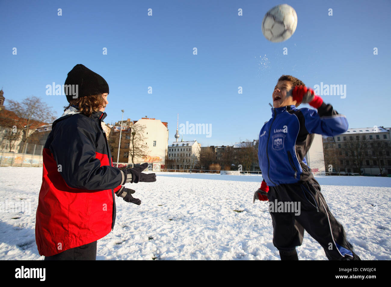 Boys playing football in the snow in Berlin Stock Photo - Alamy