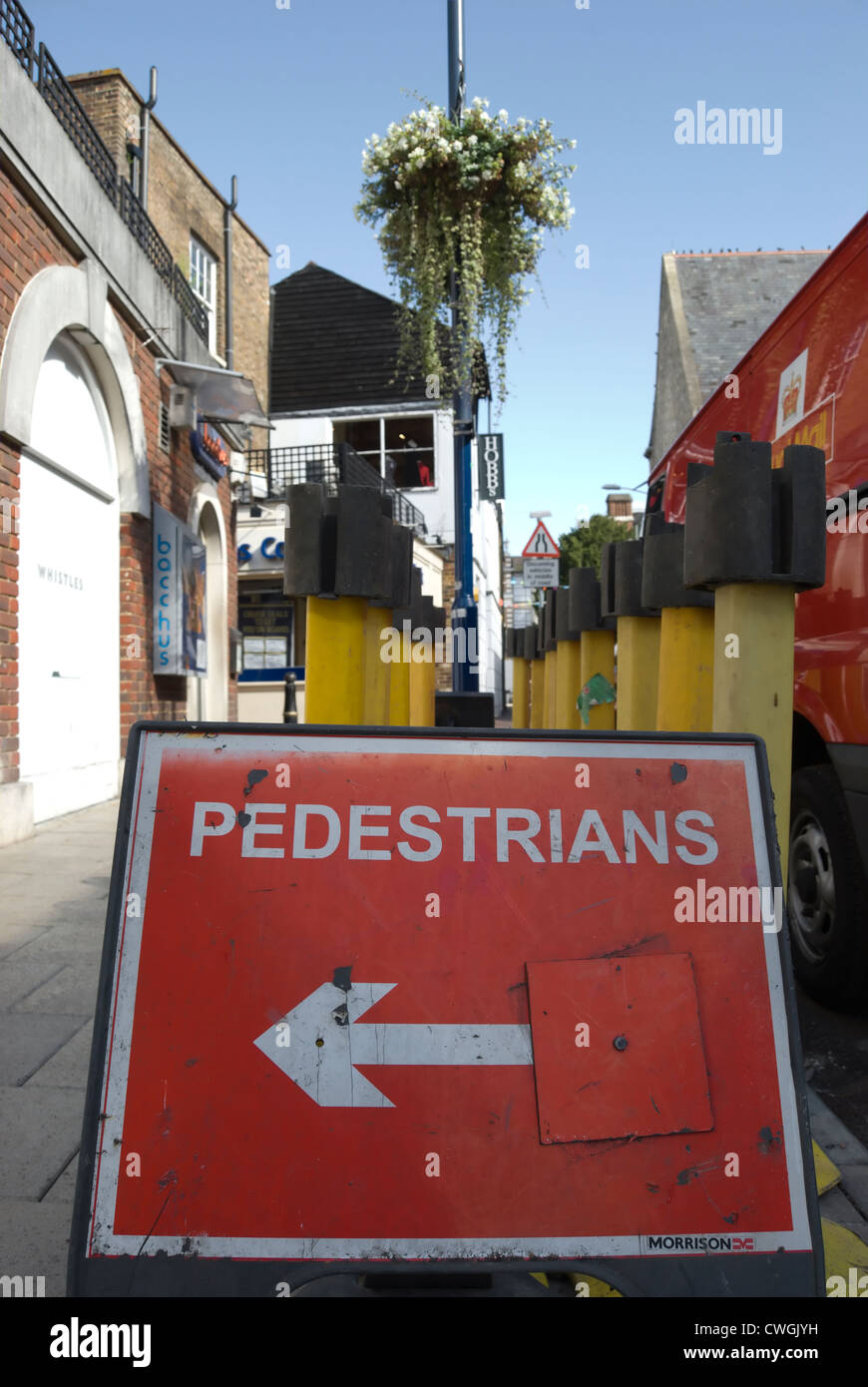 left pointing sign indicating route for pedestrians around roadworks ...