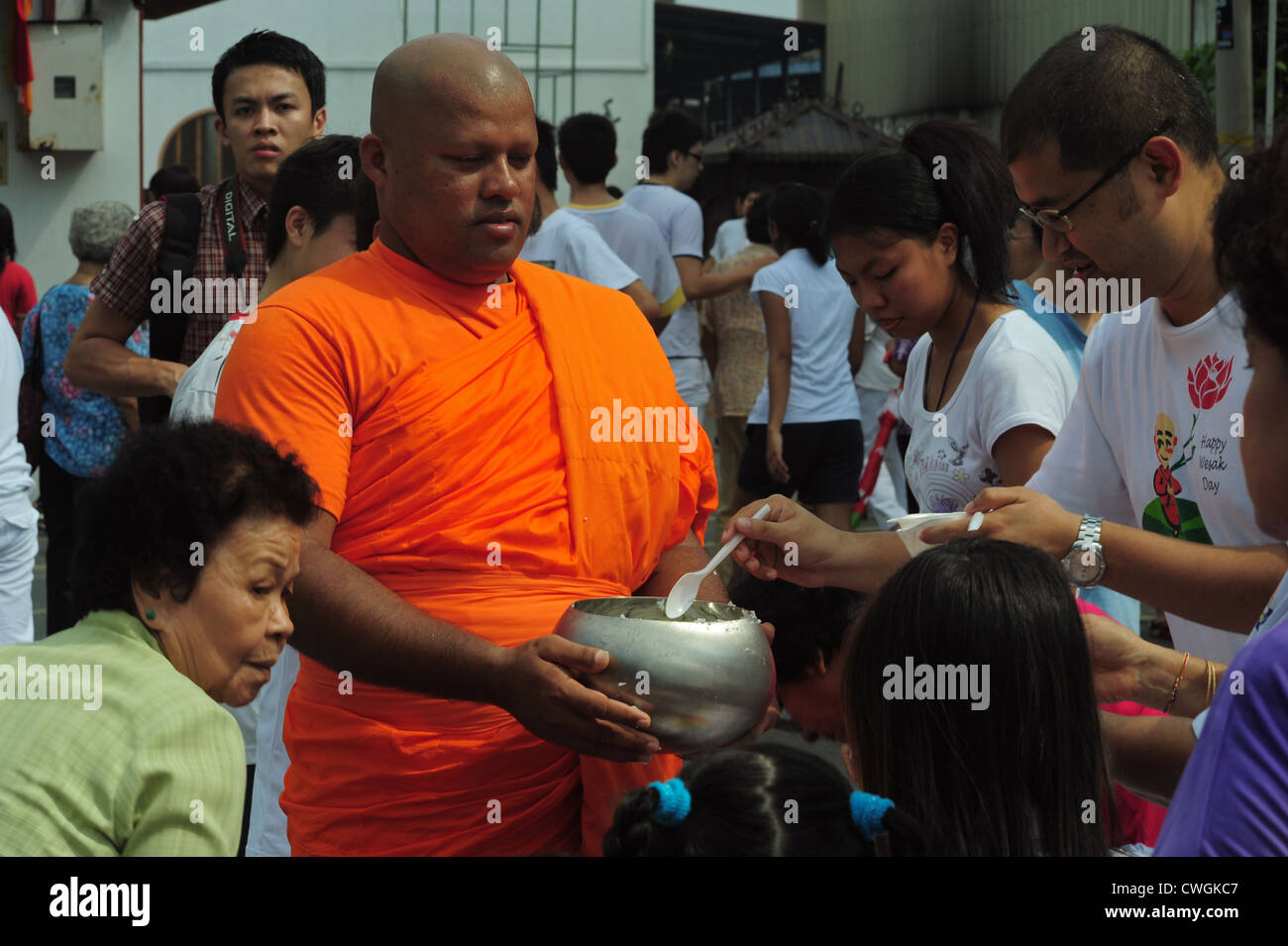 Malaysia, Melaka, buddhist monks receiving rice Stock Photo - Alamy