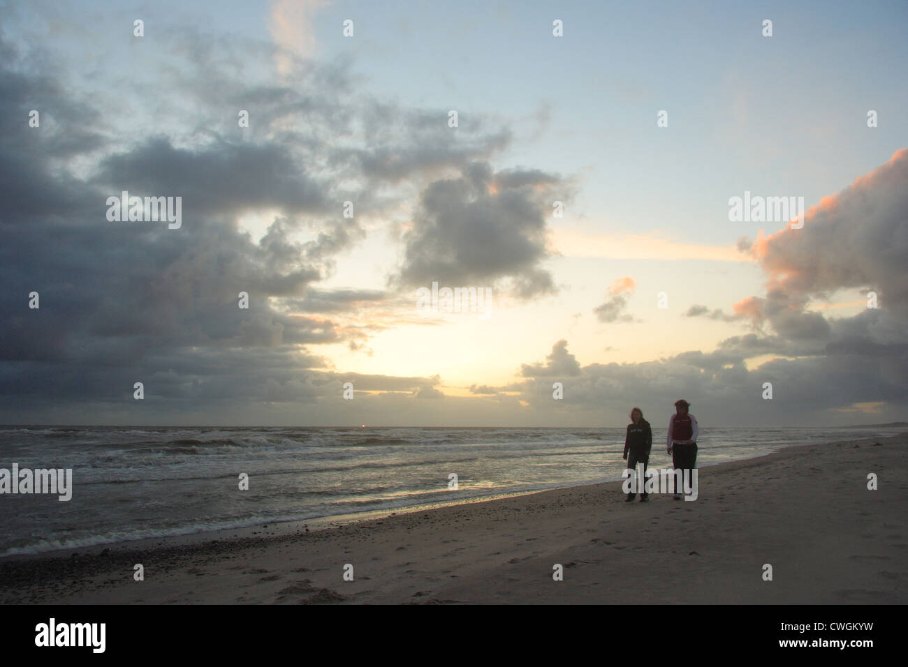 Denmark, People on the beach at sunset Stock Photo - Alamy