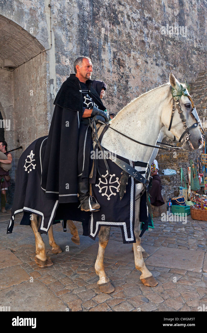 Knights riding white horses in a reenactment of a Medieval Fair in ...