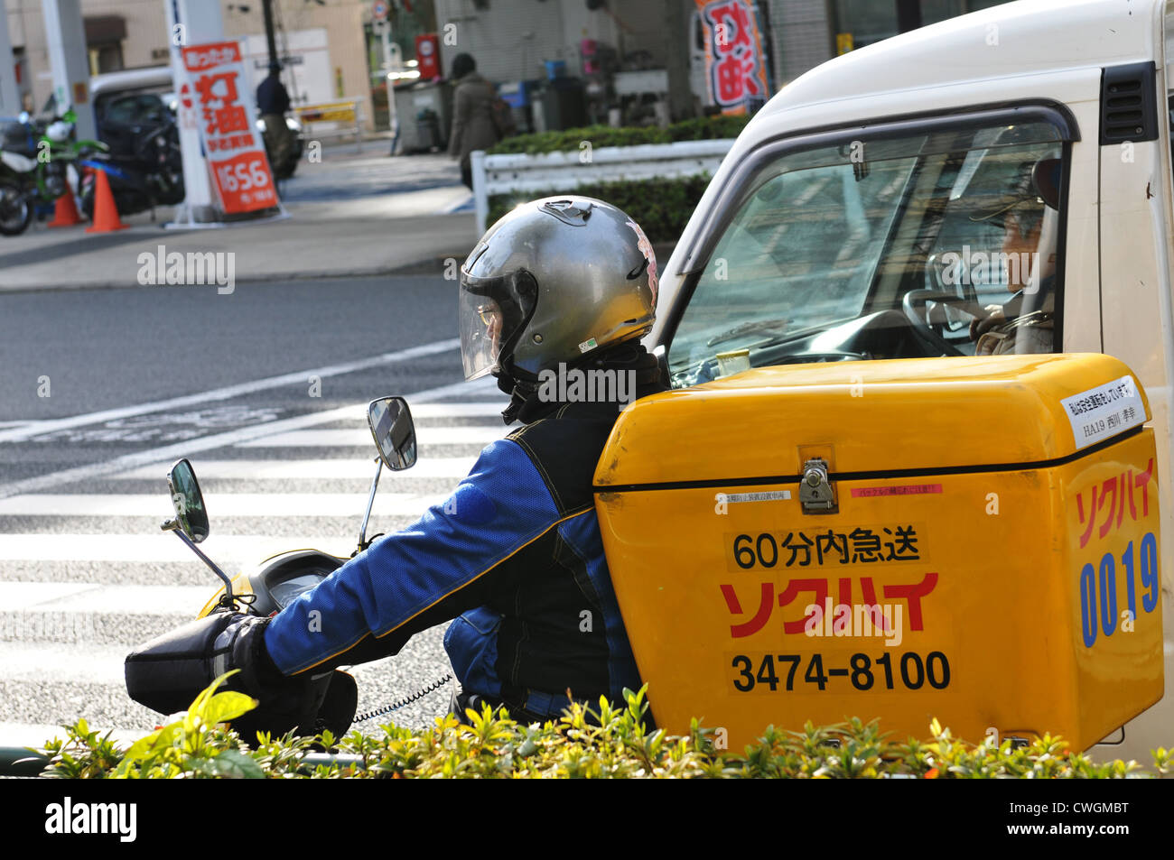 Fast delivery service by motorbike on the streets of Tokyo Stock Photo ...