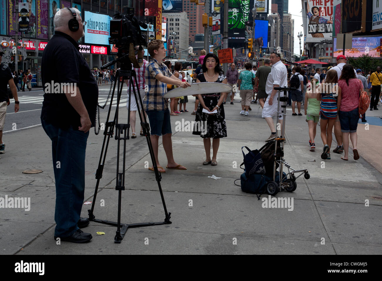 A TV film crew film a segment in Times Square New York City for the ...