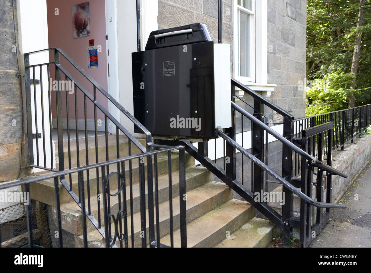 wheelchair platform lift installed outside a building with street steps ...