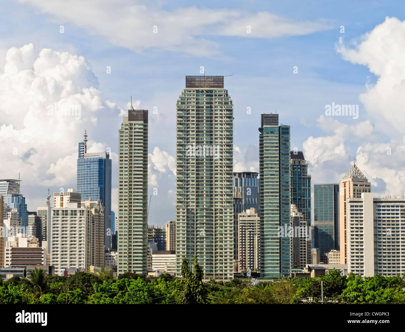 Makati skyline shot against blue sky and clouds Stock Photo - Alamy