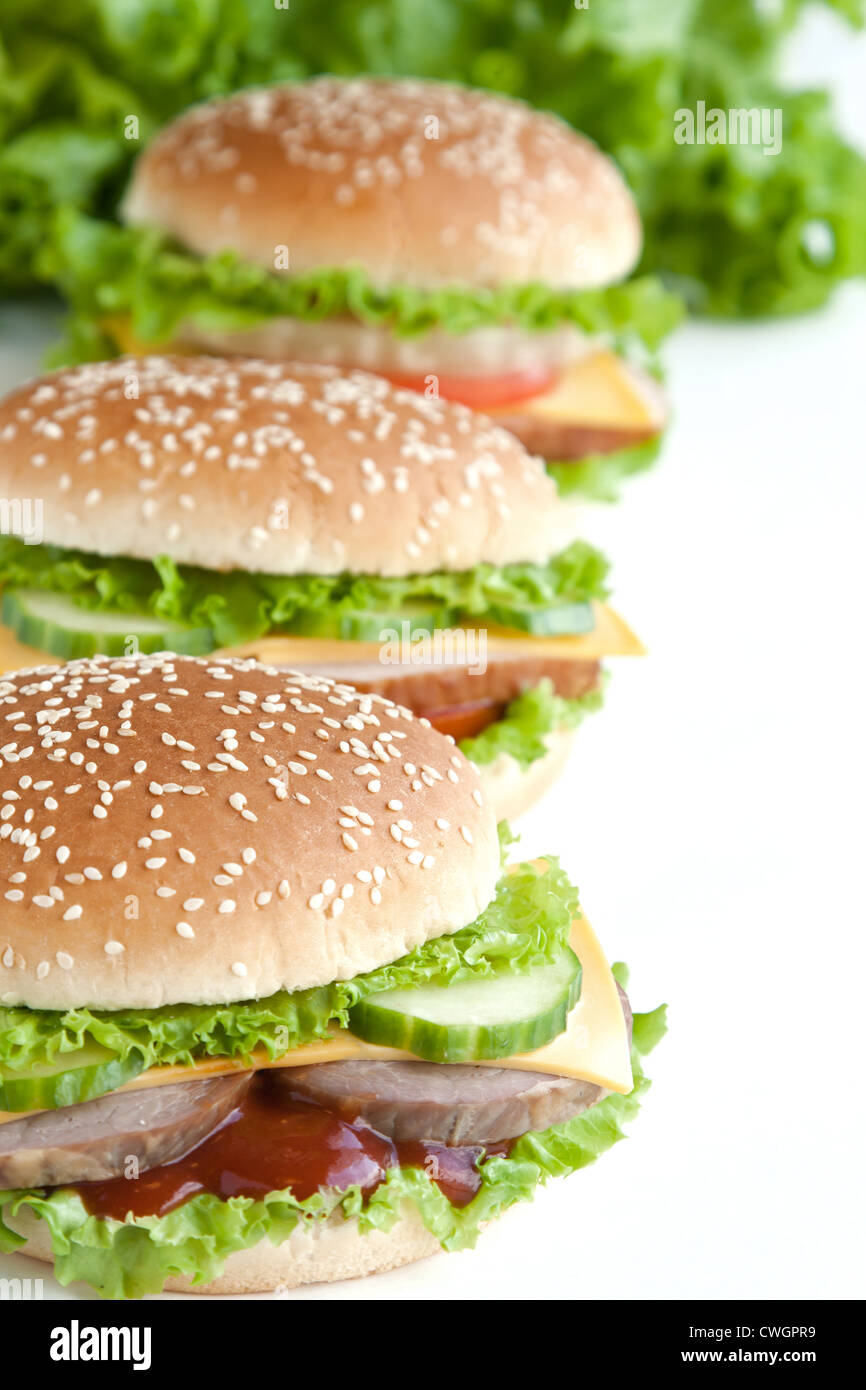 three hamburger with meat and vegetables Stock Photo - Alamy