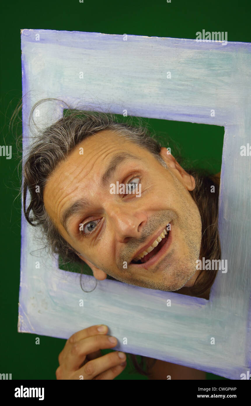 smiling funny man popping out from a picture frame Stock Photo - Alamy