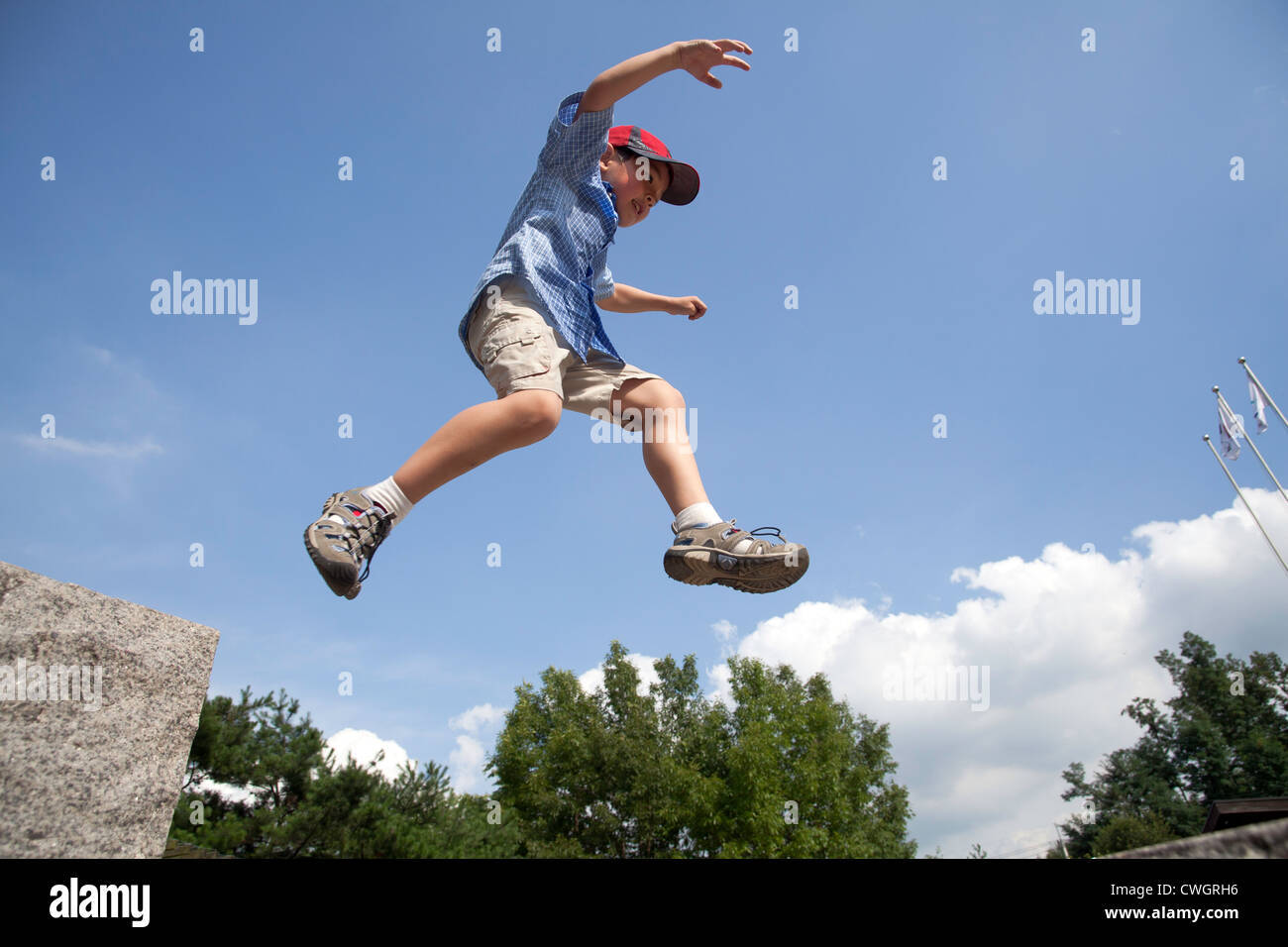 Children jumping off a rock hi-res stock photography and images - Alamy