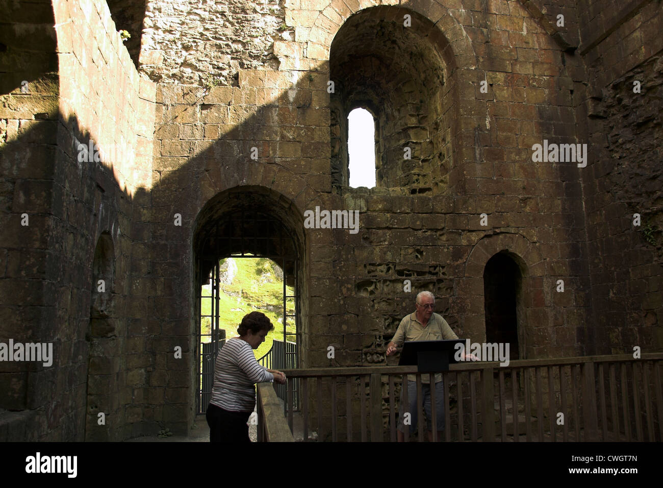 Visitors at a castle ruins interior, Peveril Castle, Castleton, Peak ...
