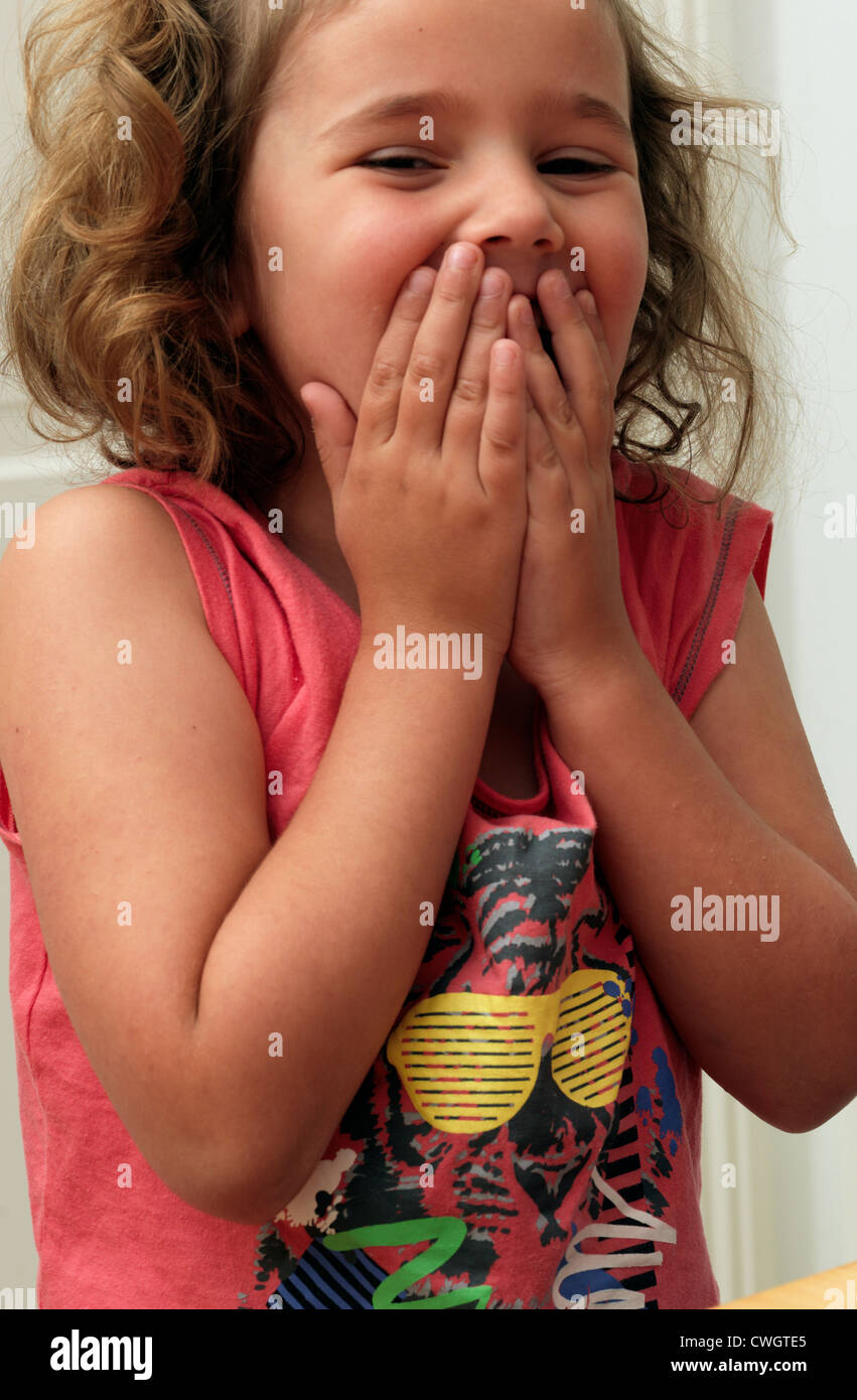 Young Girl Laughing With Hands Covering Her Mouth England Stock Photo ...