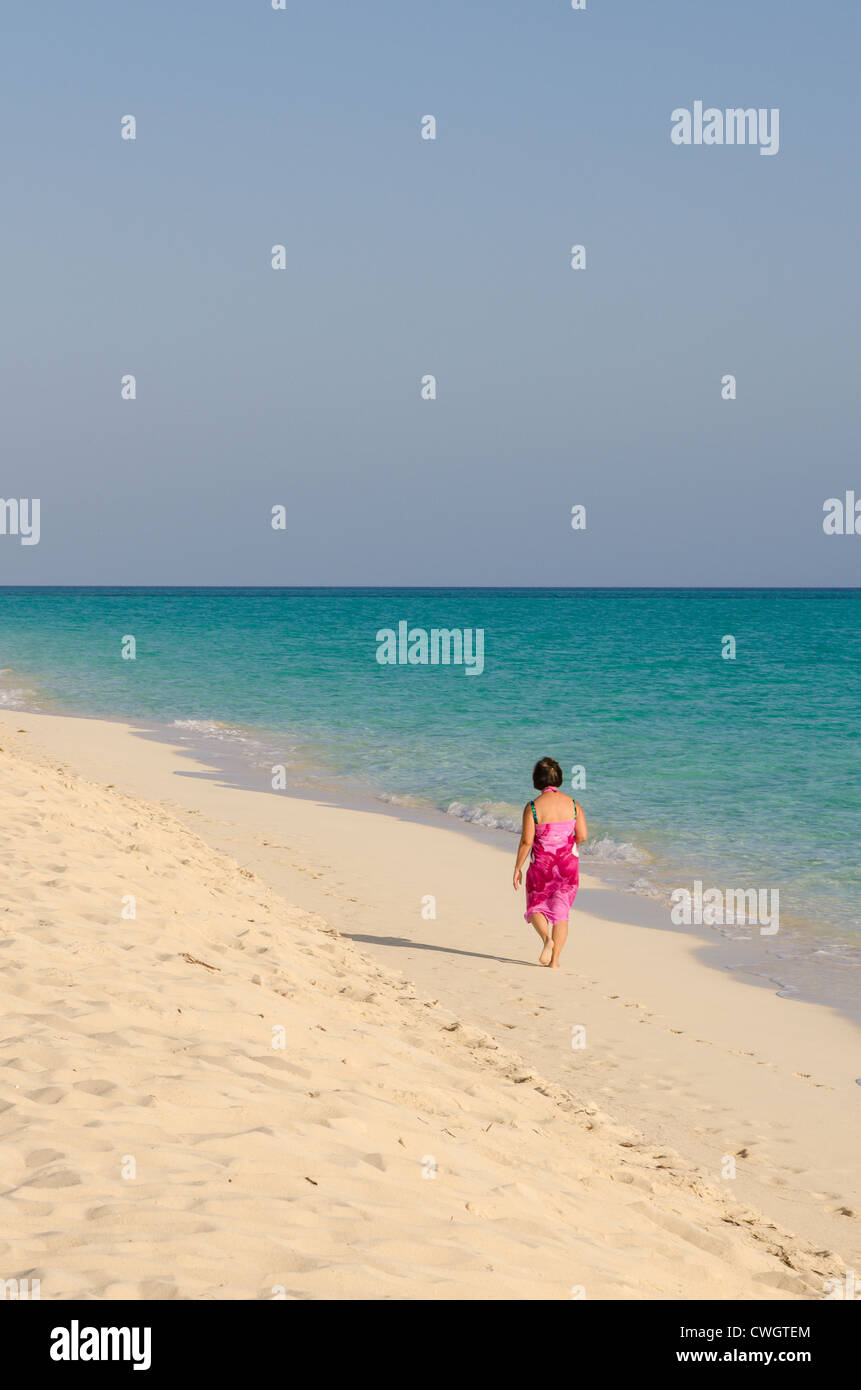 Woman and footprints footsteps on beach at Sol Cayo Santa Maria Resort ...