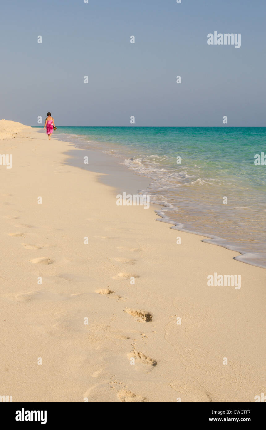 Woman and footprints footsteps on beach at Sol Cayo Santa Maria Resort ...