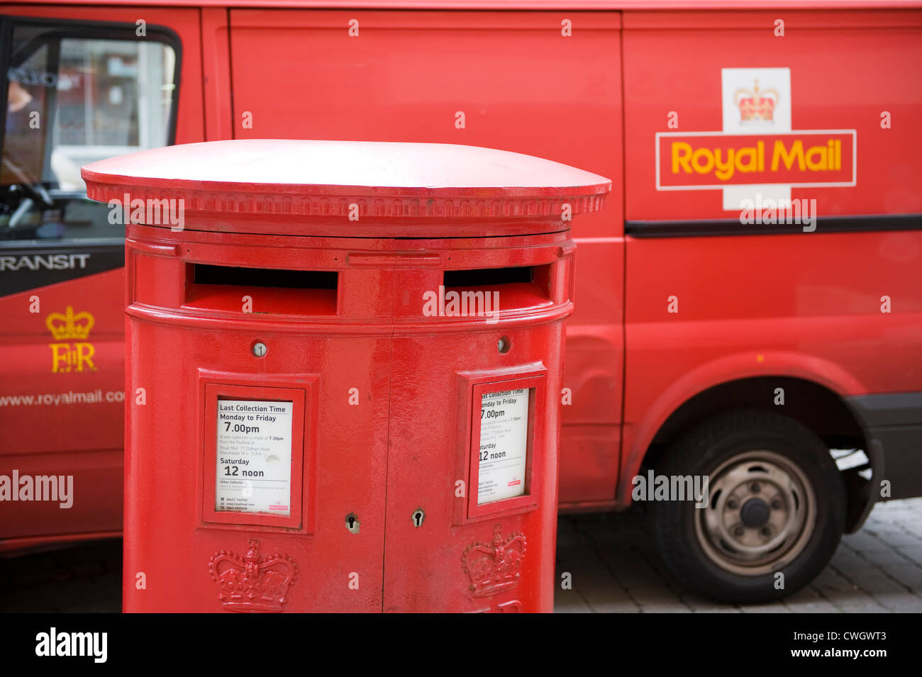 royal mail double red letter box with a royal mail red van parked ...