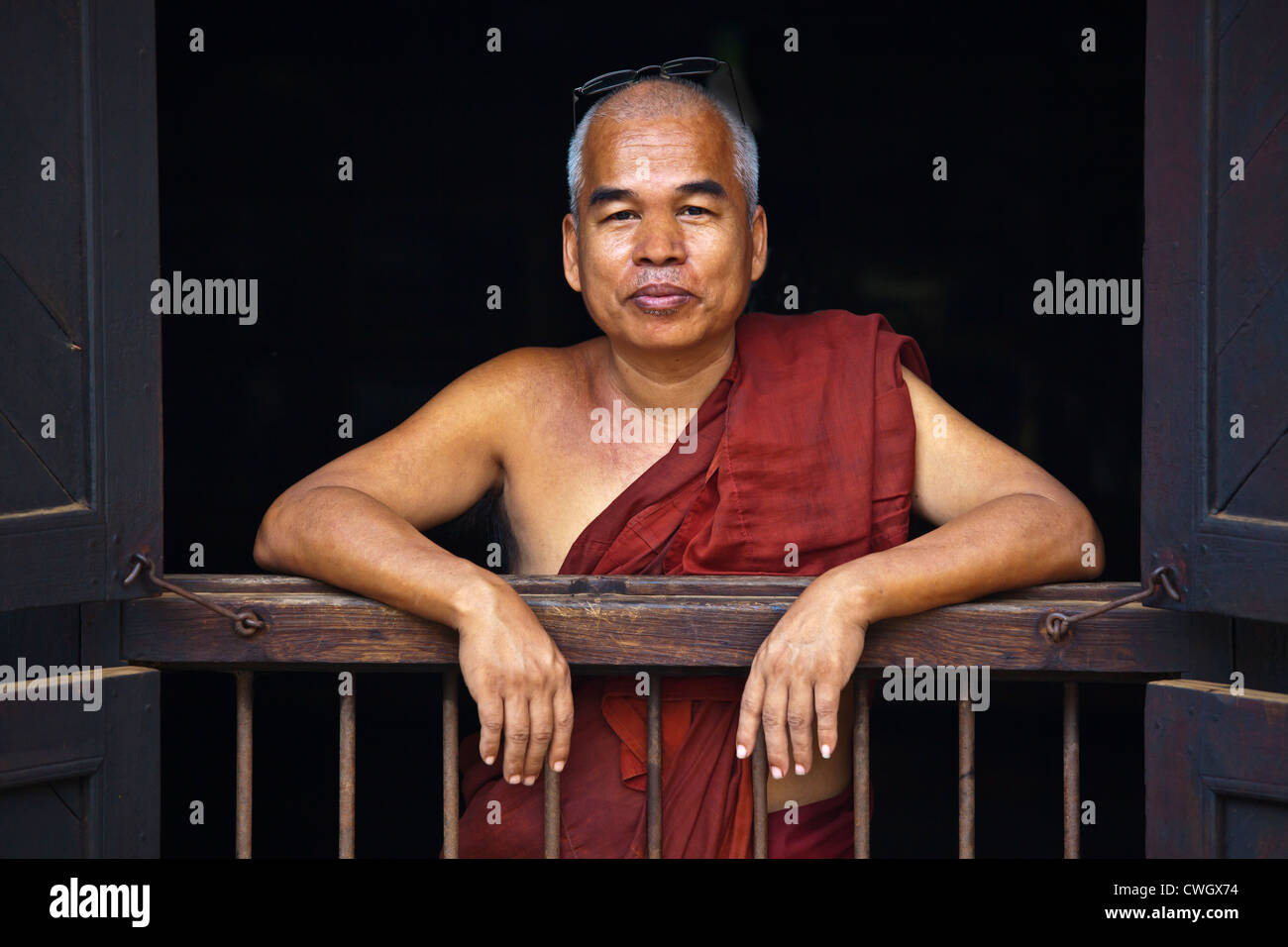 A MONK at the teak BAGAYA KYAUNG MONASTERY built in1834 in INWA served ...
