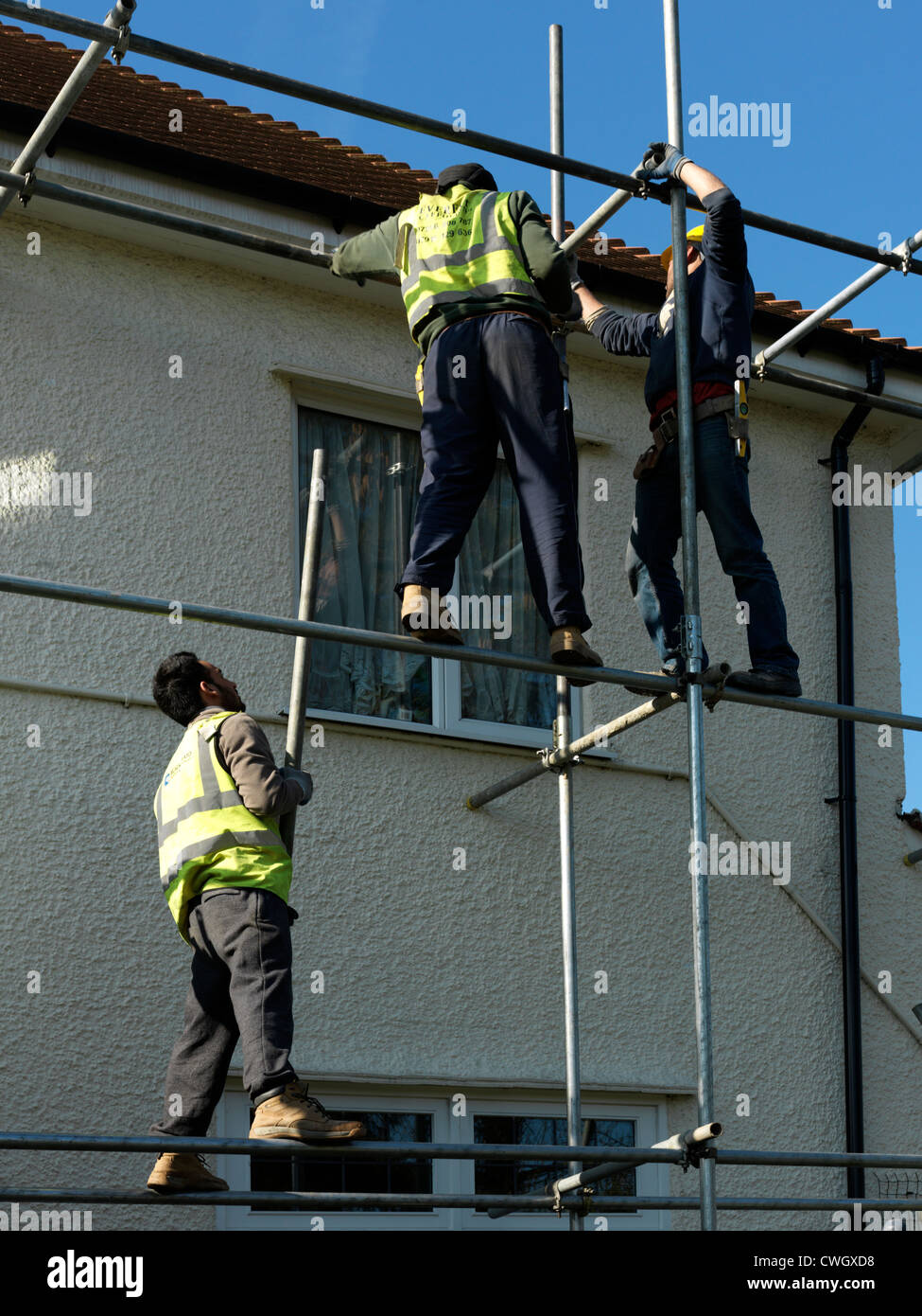 Sikh Workmen Putting Up Scaffolding Around A House England Surrey Stock ...
