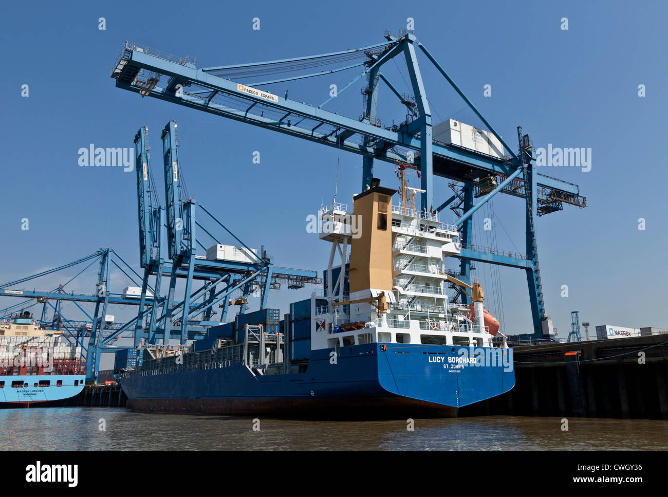 Container Ship being loaded on the river Stock Photo - Alamy