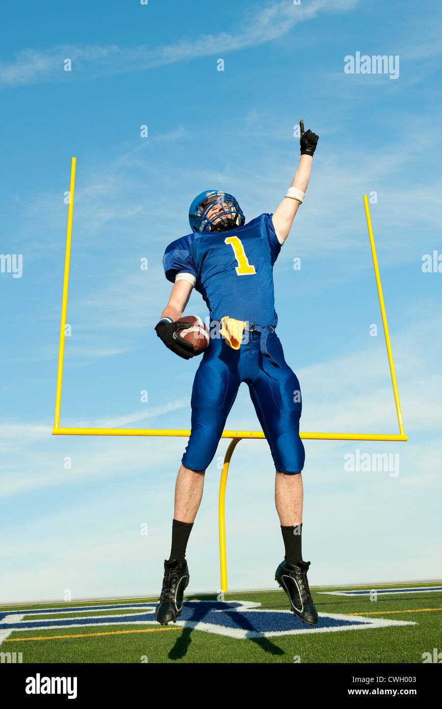 Caucasian football player cheering for victory Stock Photo - Alamy