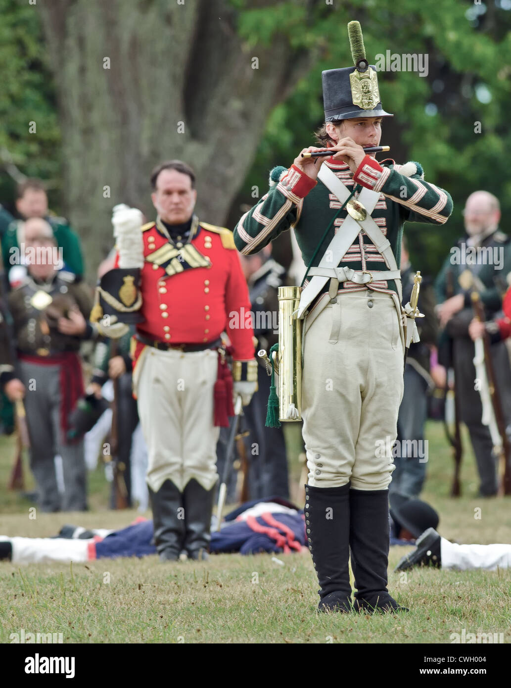 A lone piper plays a lament for the fallen after the battle August 11/ ...