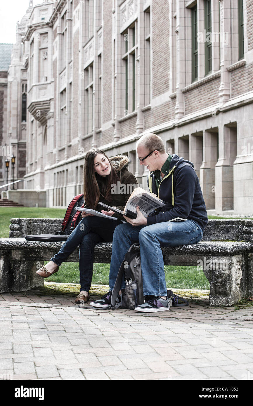 Students sitting on bench together Stock Photo - Alamy