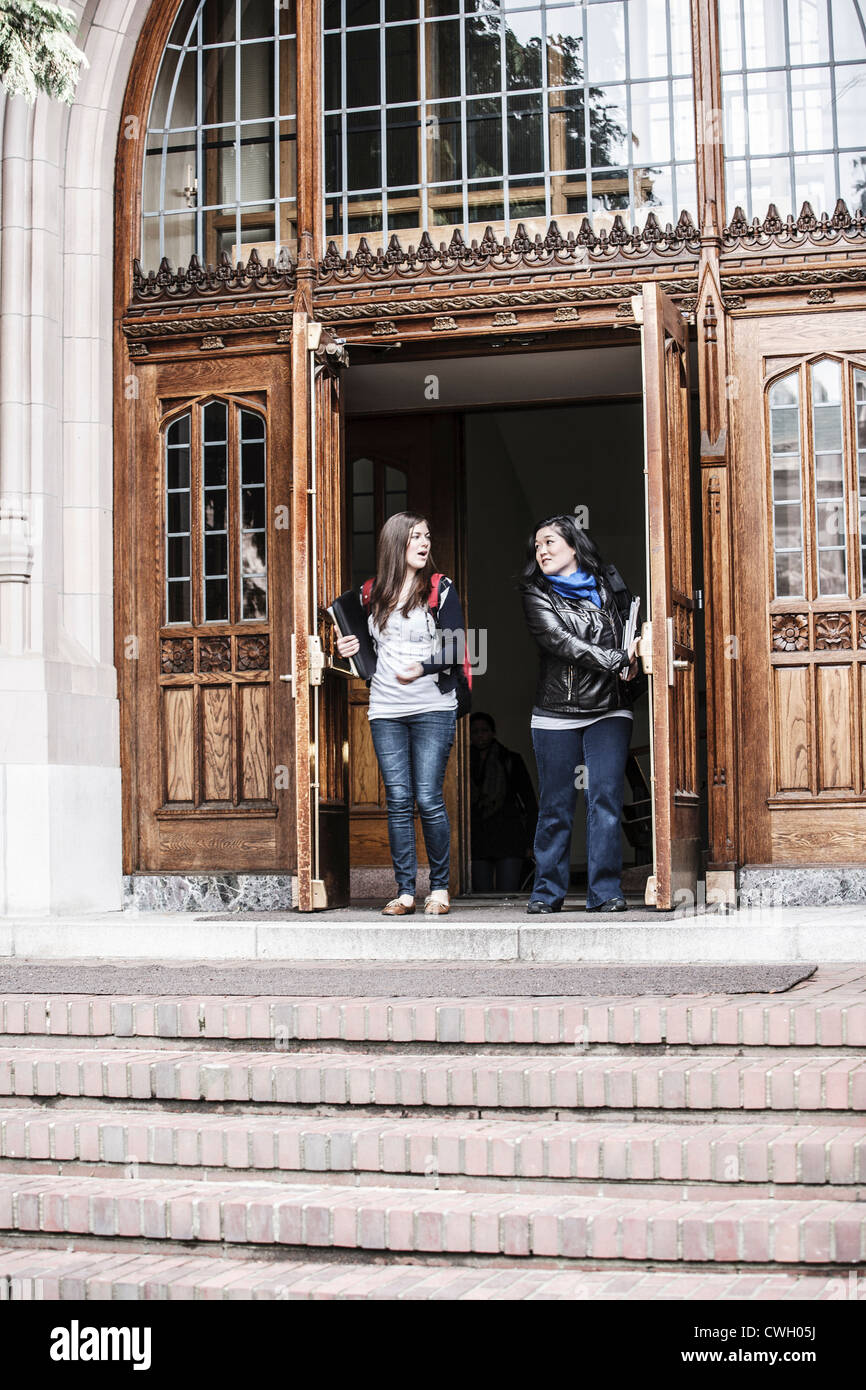 Students coming out of college doorway Stock Photo - Alamy