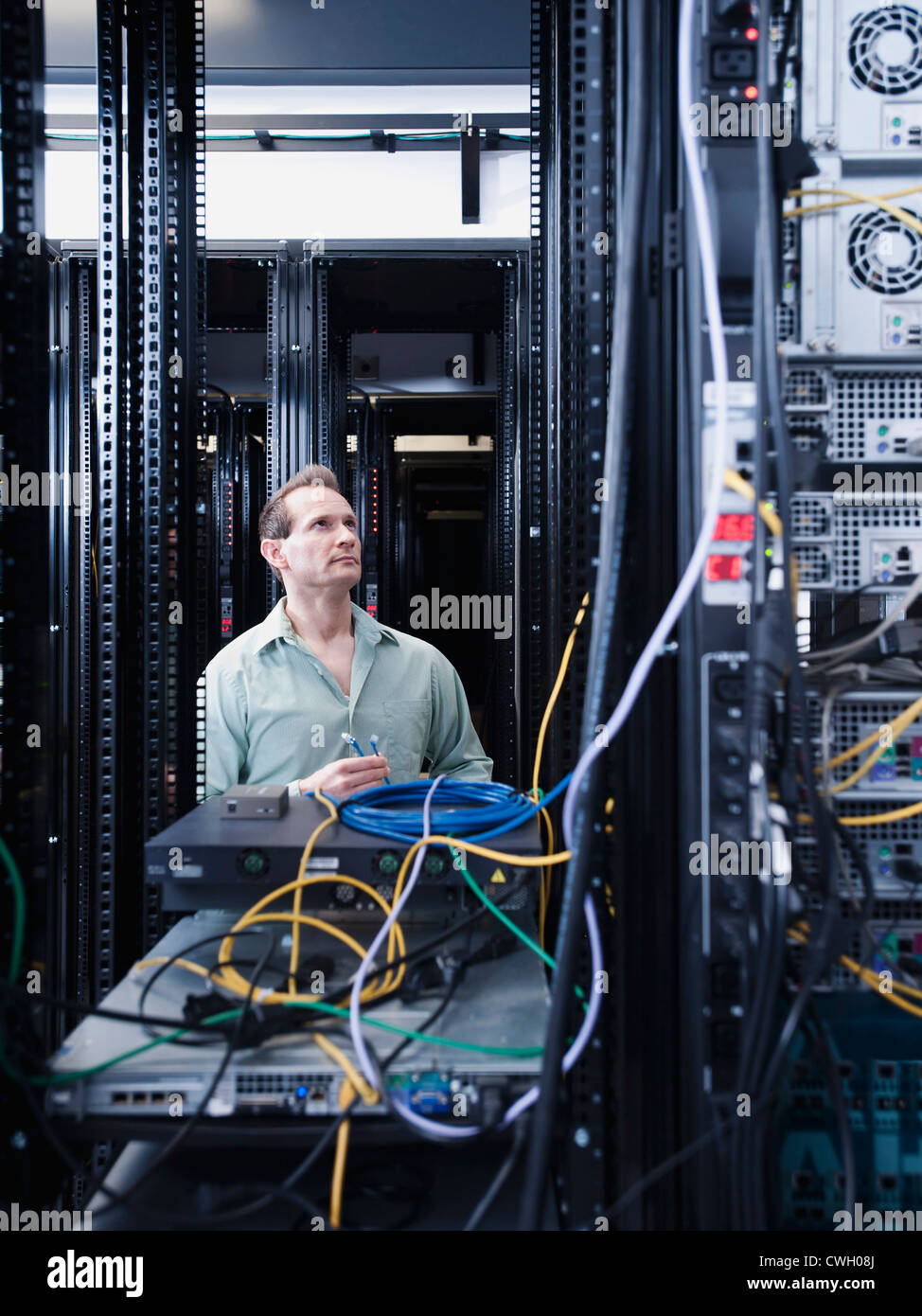 Caucasian businessman working in server room Stock Photo - Alamy