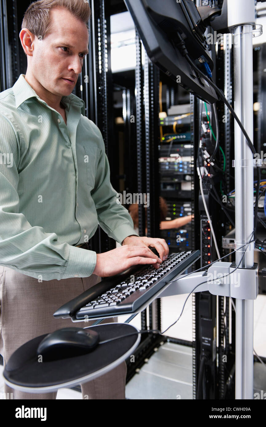 Caucasian businessman working in server room Stock Photo - Alamy