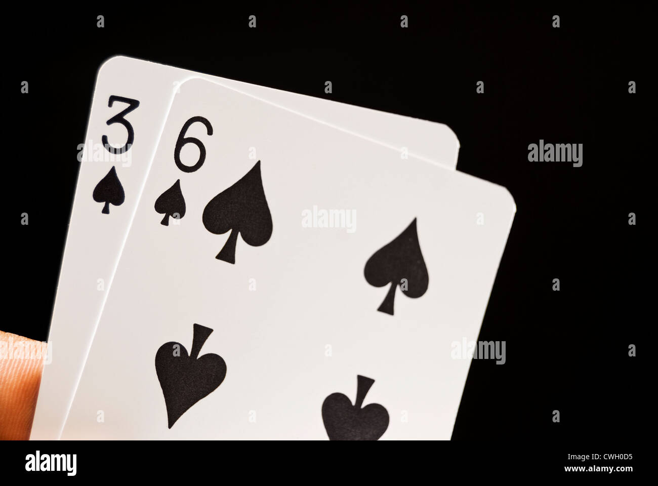 Lucky Nine cards held by hand against black background Stock Photo - Alamy