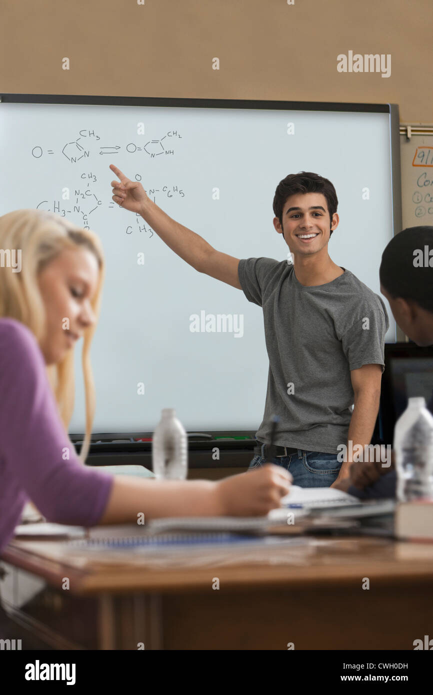Student explaining formula in classroom Stock Photo - Alamy
