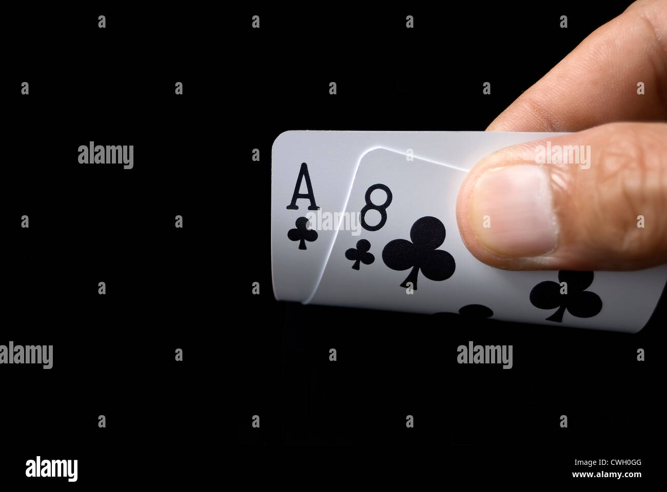 Lucky Nine cards held by hand against black background Stock Photo - Alamy