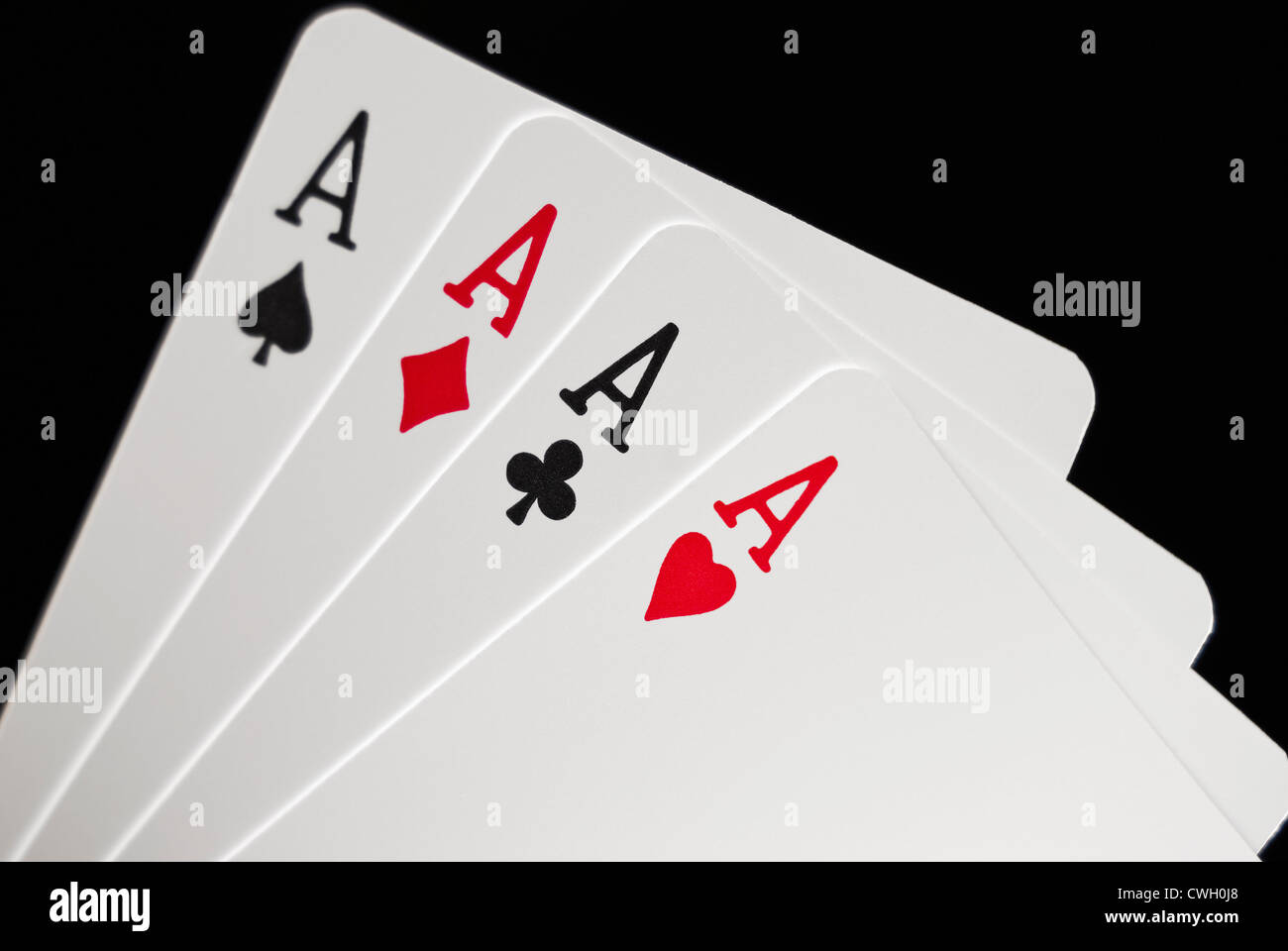 Four Aces against black background Stock Photo - Alamy